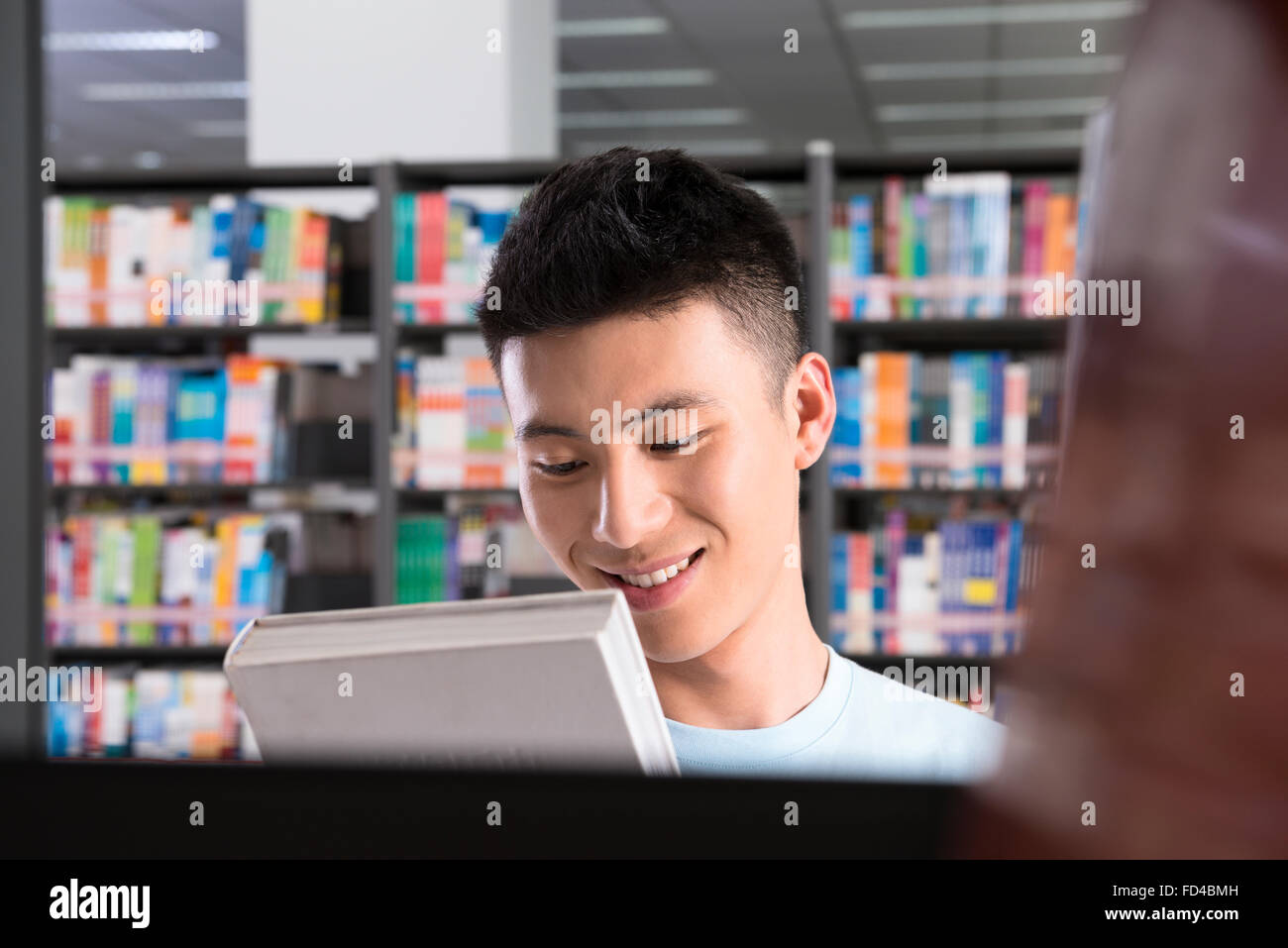 Portrait of college student in library Stock Photo - Alamy