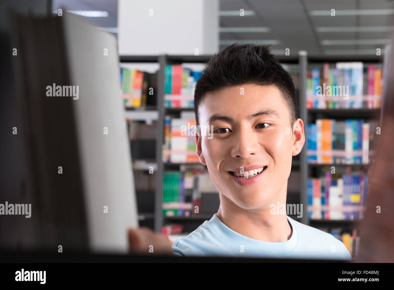 Portrait of college student in library Stock Photo - Alamy