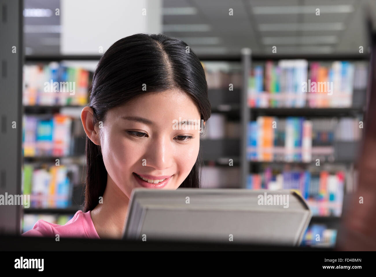 Portrait of college student in library Stock Photo - Alamy
