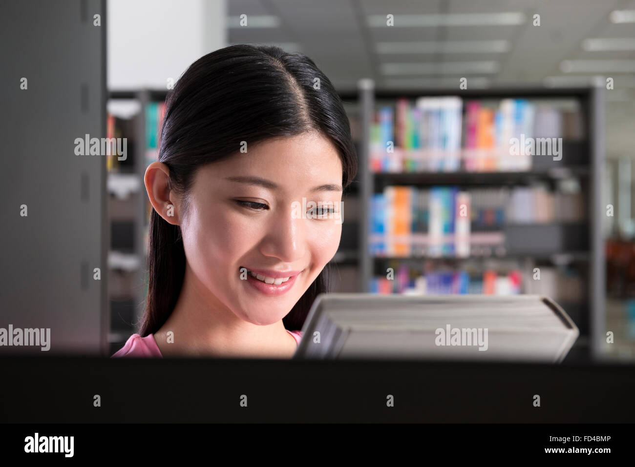 Portrait of college student in library Stock Photo - Alamy