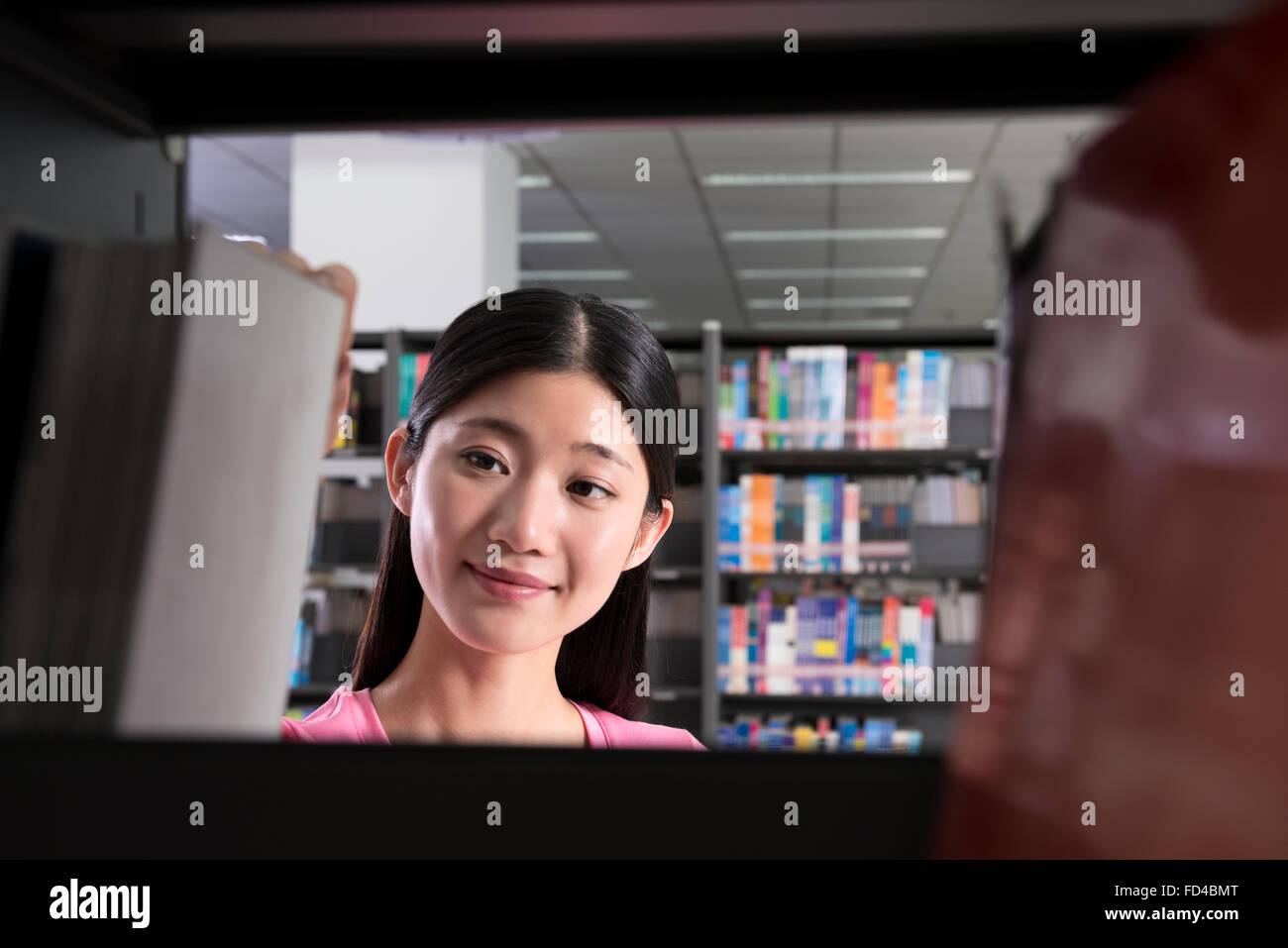 Portrait of college student in library Stock Photo - Alamy