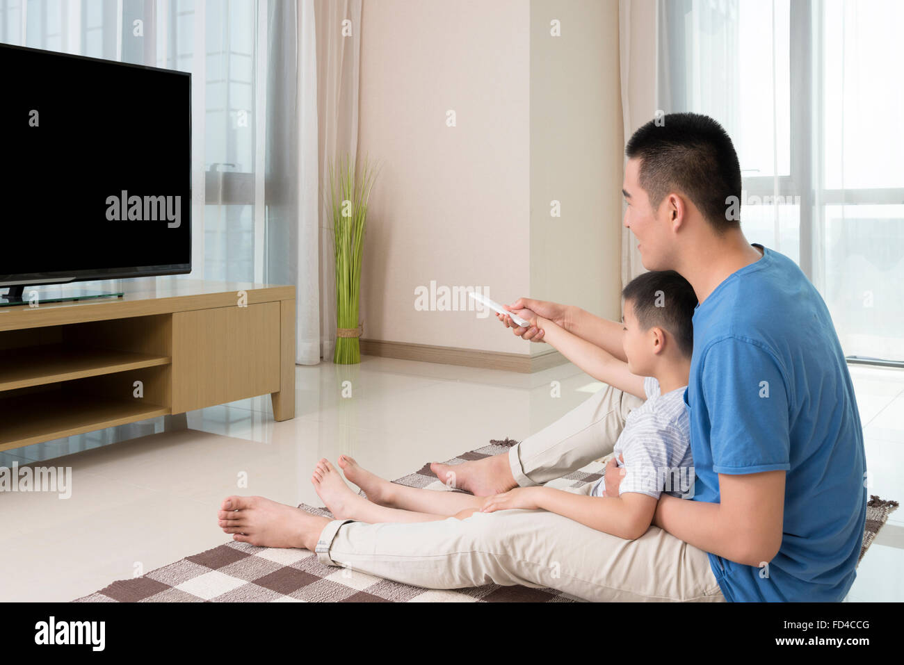 Father and son watching TV Stock Photo - Alamy