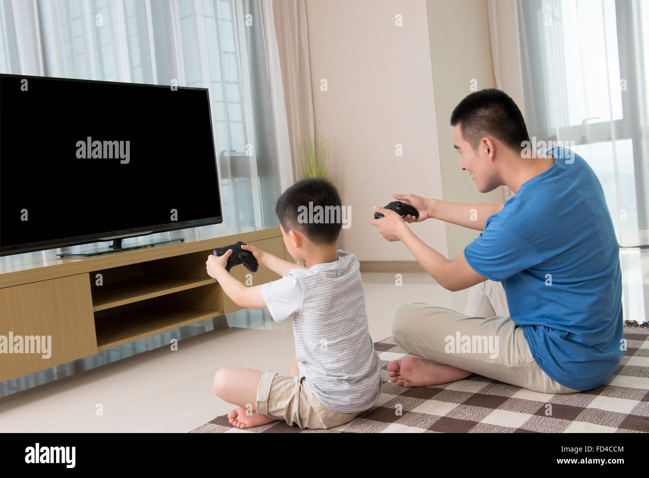 Father and son playing video games Stock Photo - Alamy