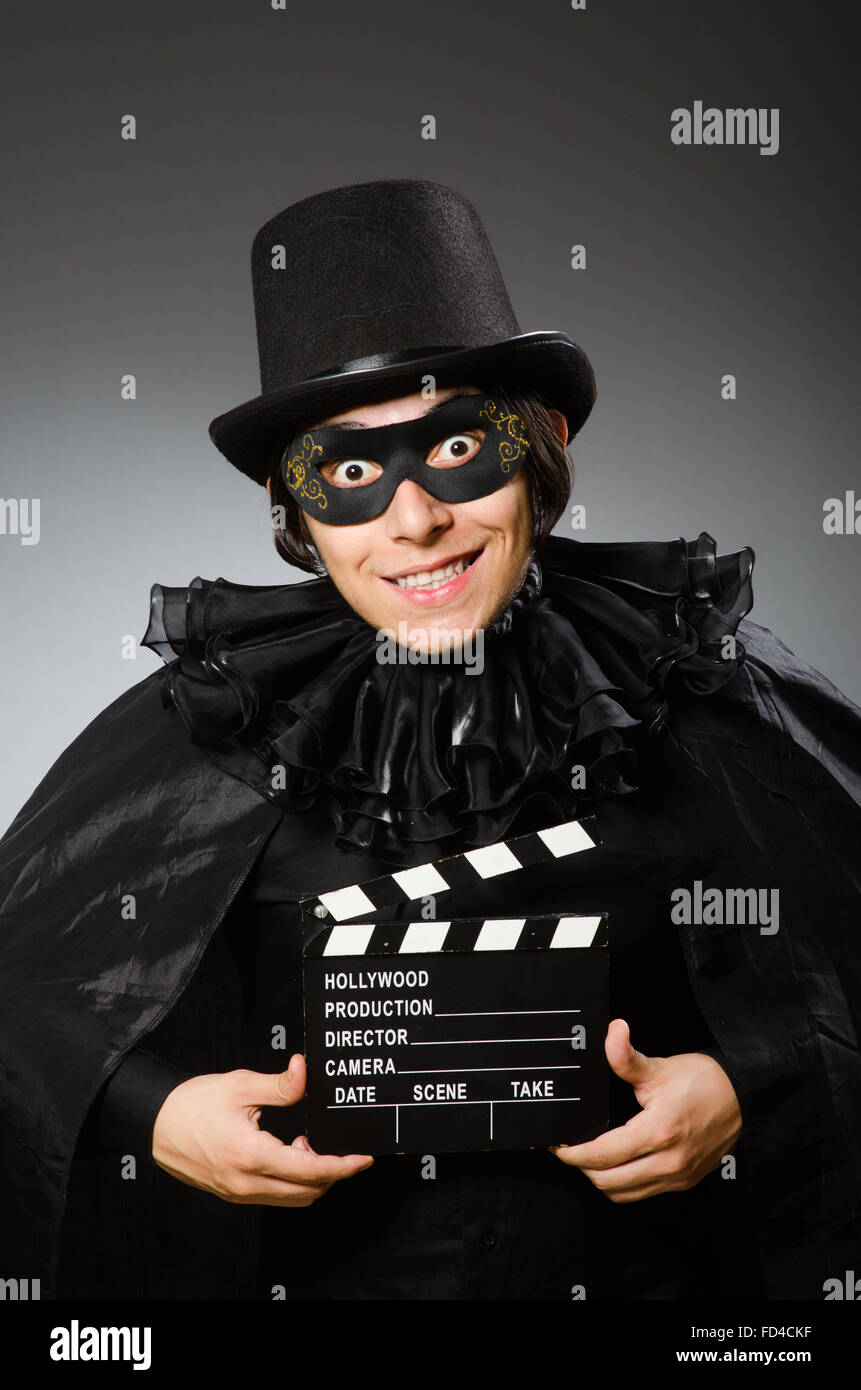 The man wearing mask with movie board Stock Photo - Alamy