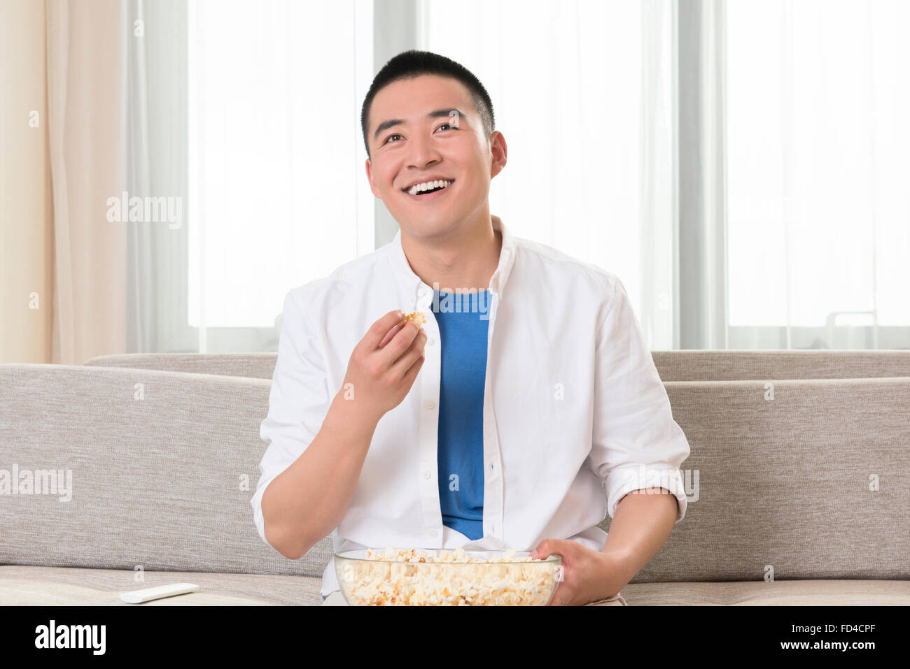 Young man watching TV Stock Photo - Alamy