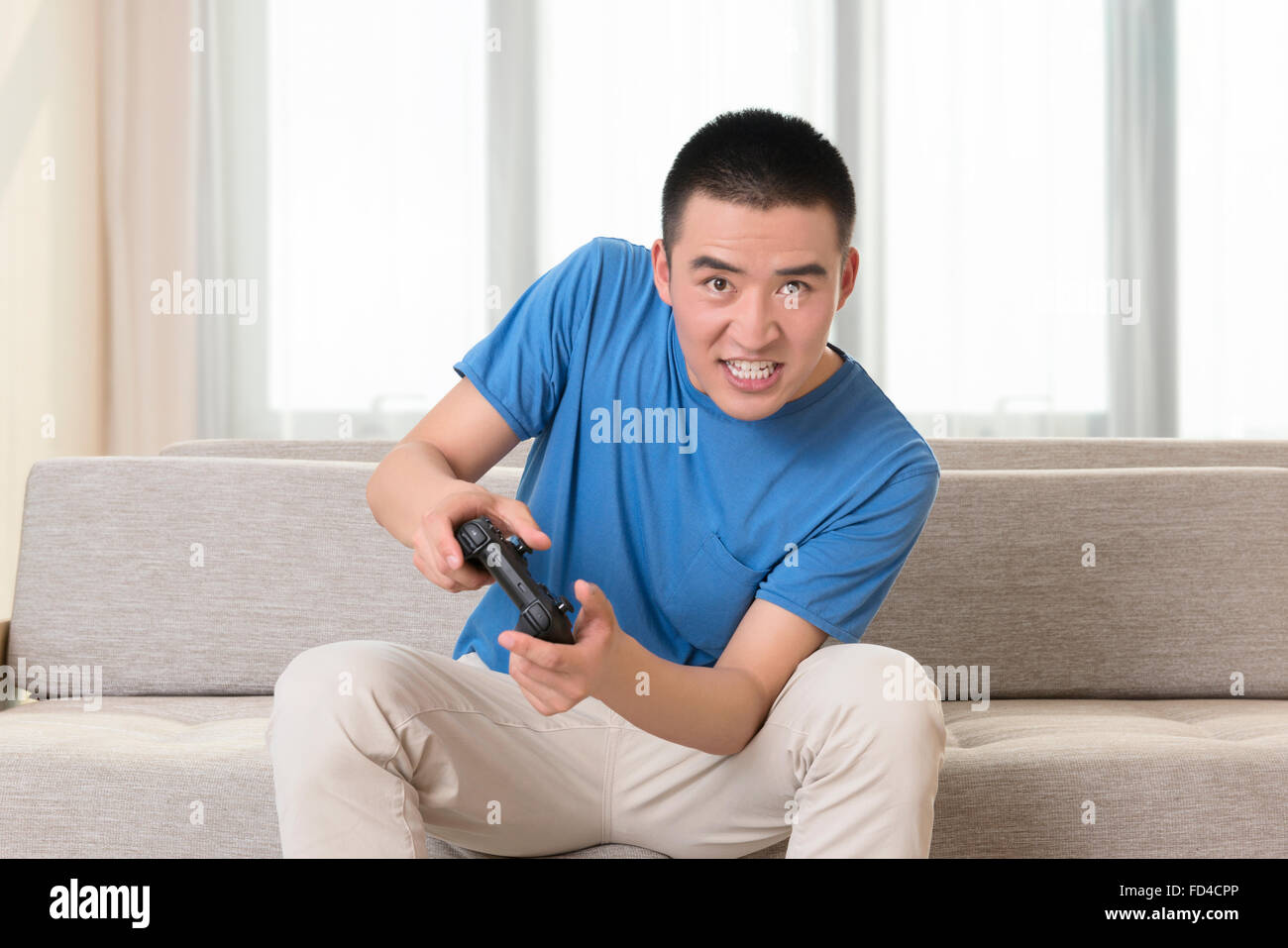 Young man playing video games Stock Photo - Alamy