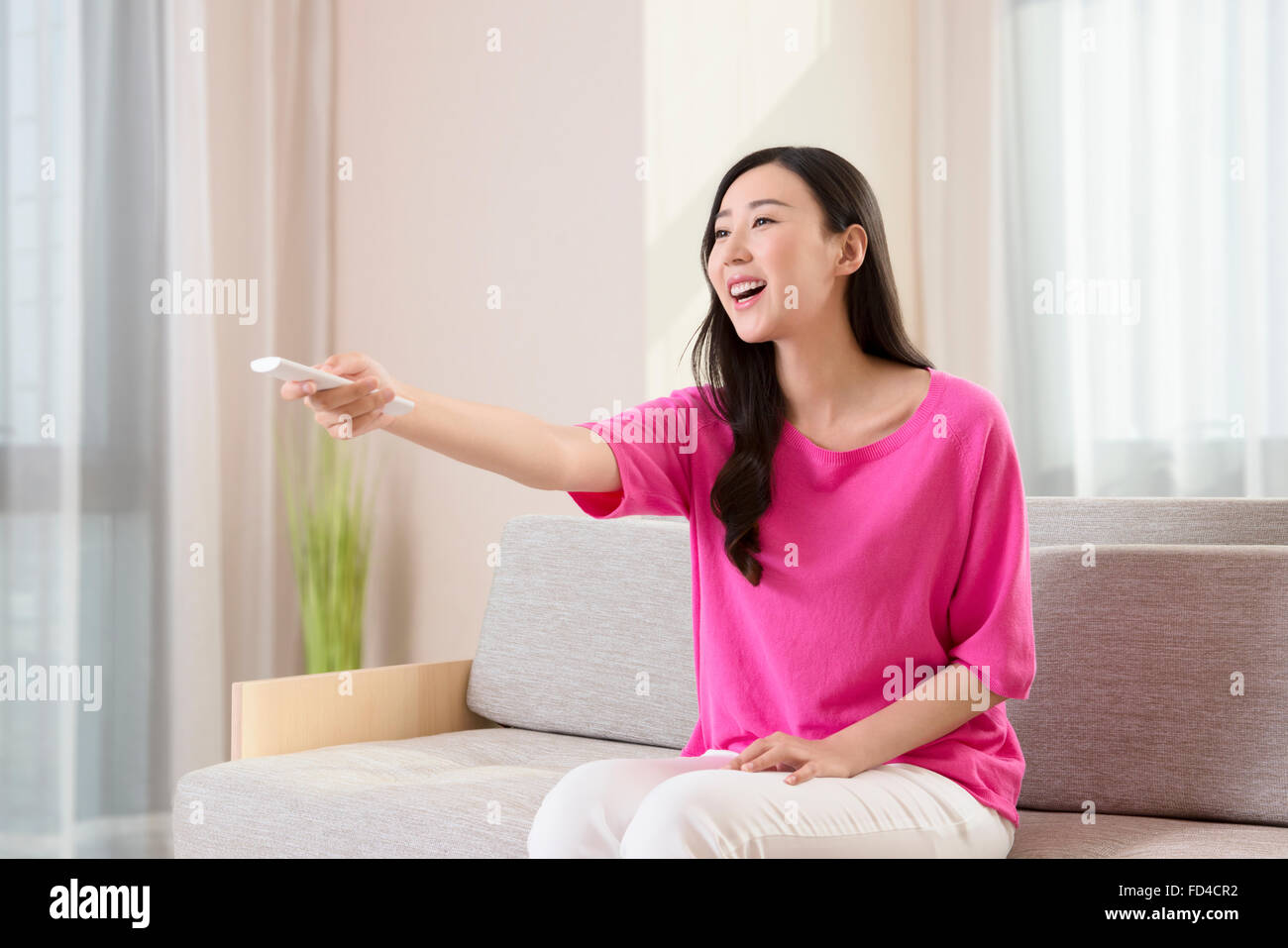 Woman pointing remote control hi-res stock photography and images - Alamy