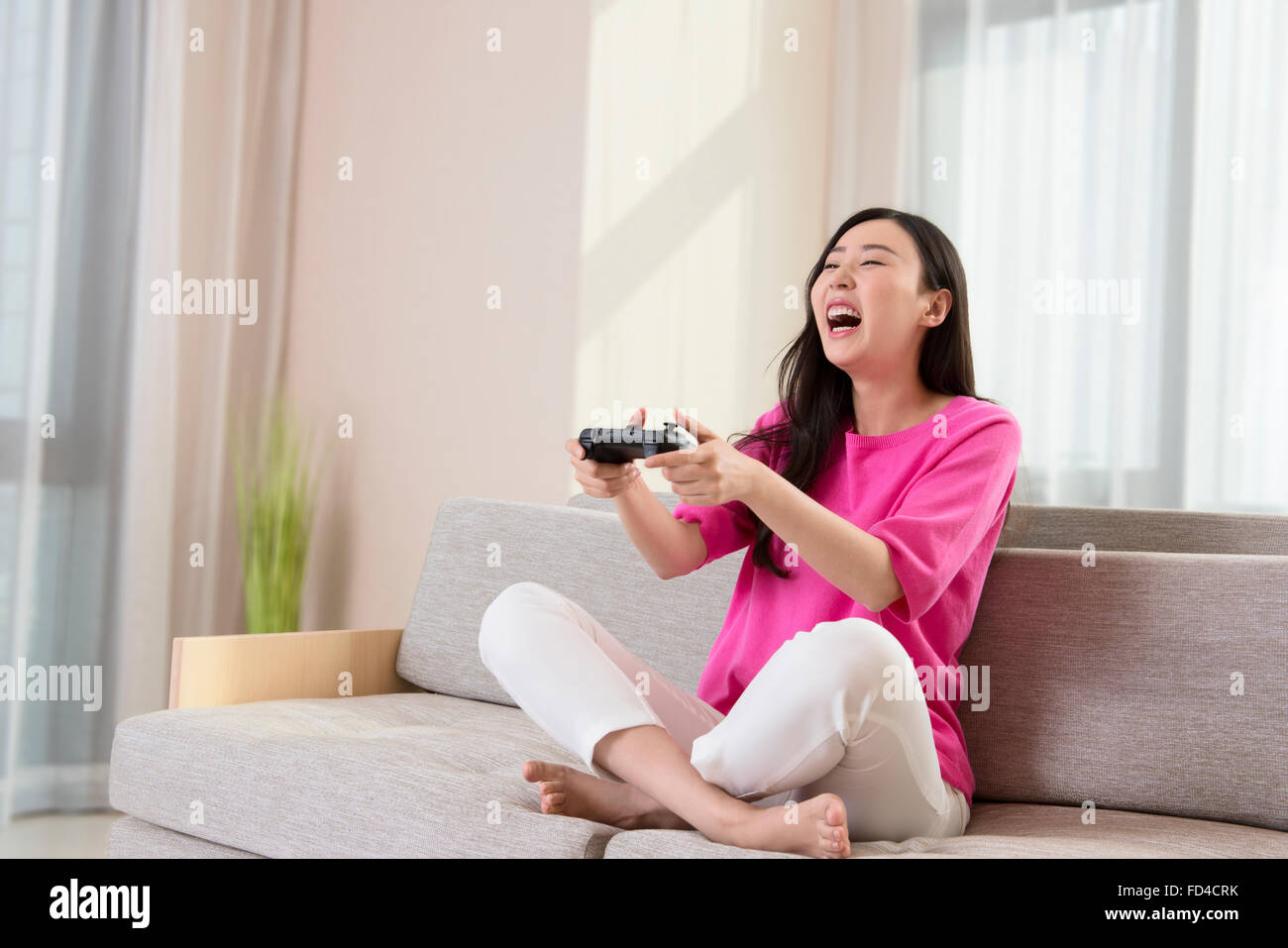 Young woman playing video games Stock Photo - Alamy