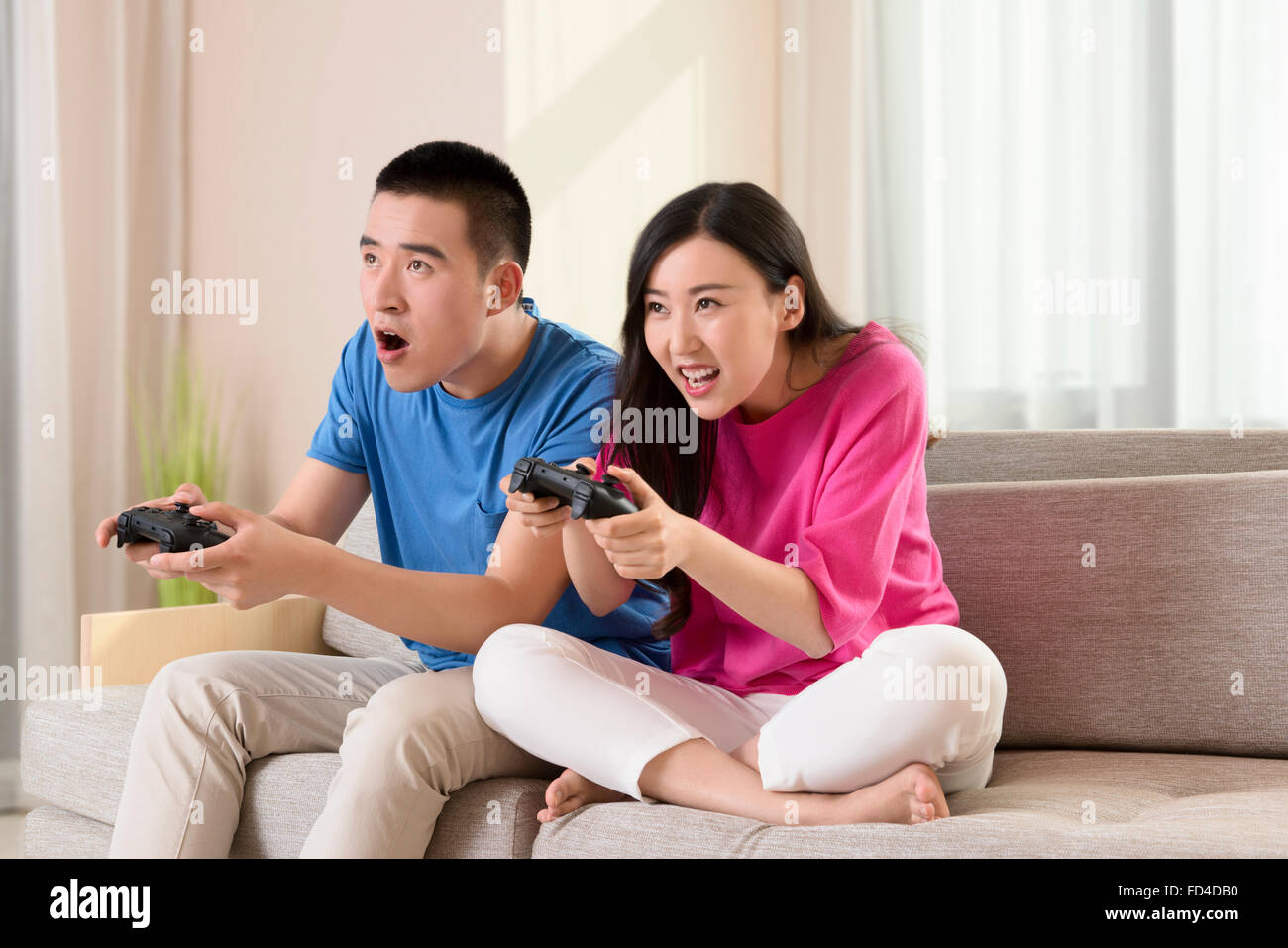 Young couple playing video games Stock Photo - Alamy
