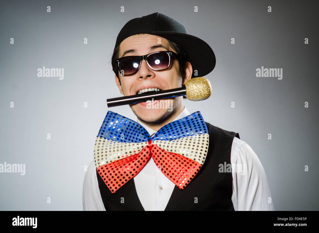 The funny man with mic in karaoke concept Stock Photo - Alamy