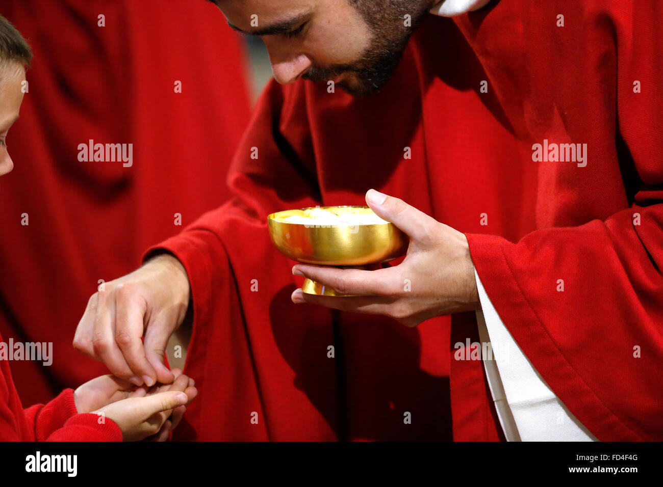 Newly ordained priest giving holy communion in Notre-Dame de Paris ...