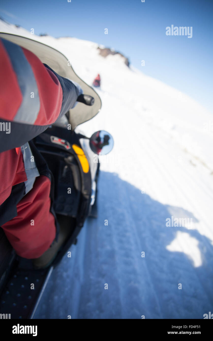 Person Riding Snowmobile On Mountains Stock Photo - Alamy