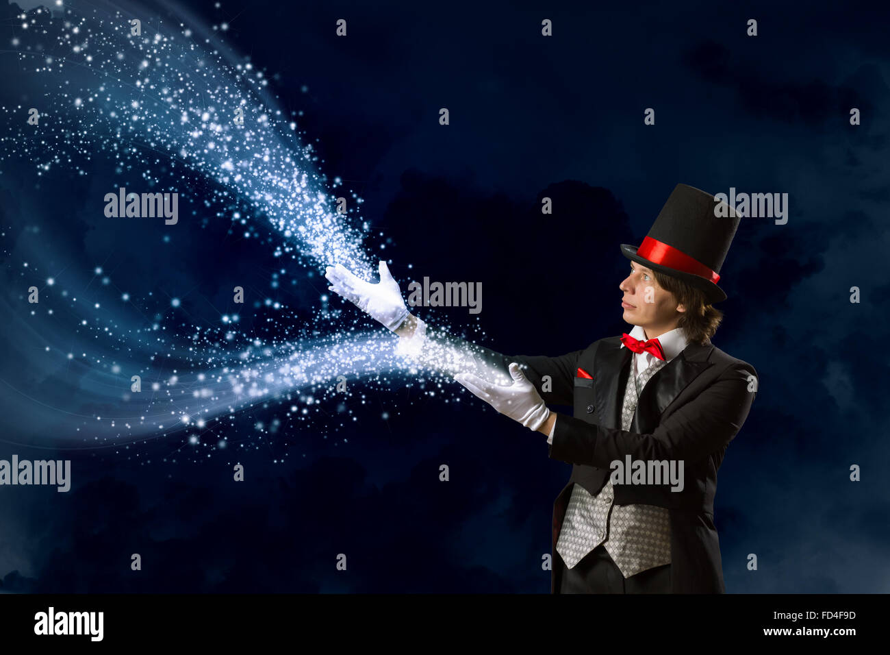 Image of wizard in red bow tie showing tricks Stock Photo - Alamy