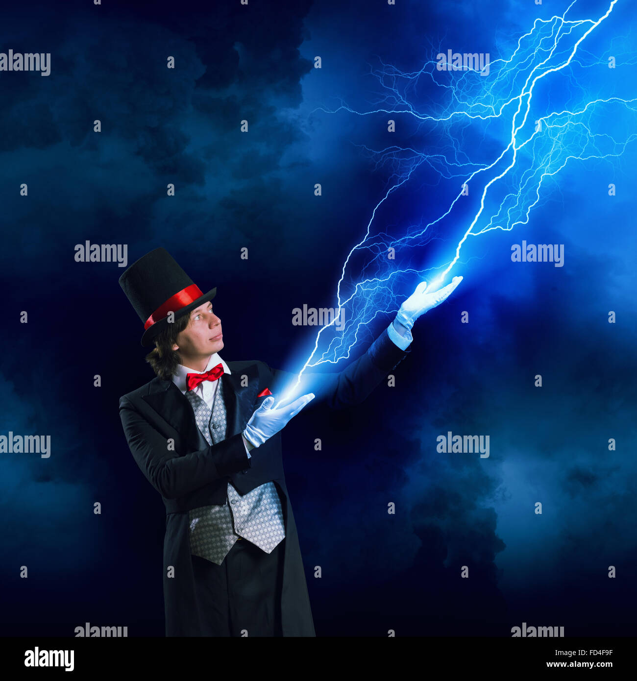 Image of wizard in red bow tie showing tricks Stock Photo - Alamy