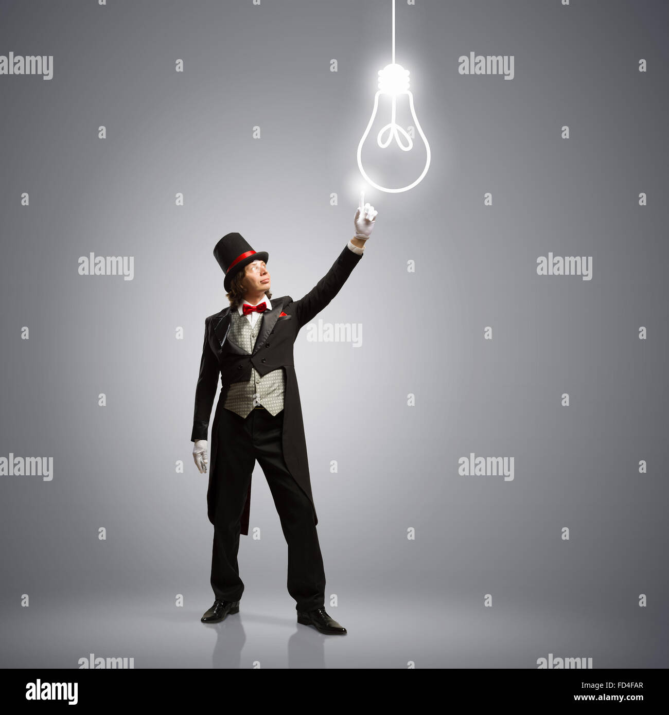 Image of man magician showing trick against color background Stock ...