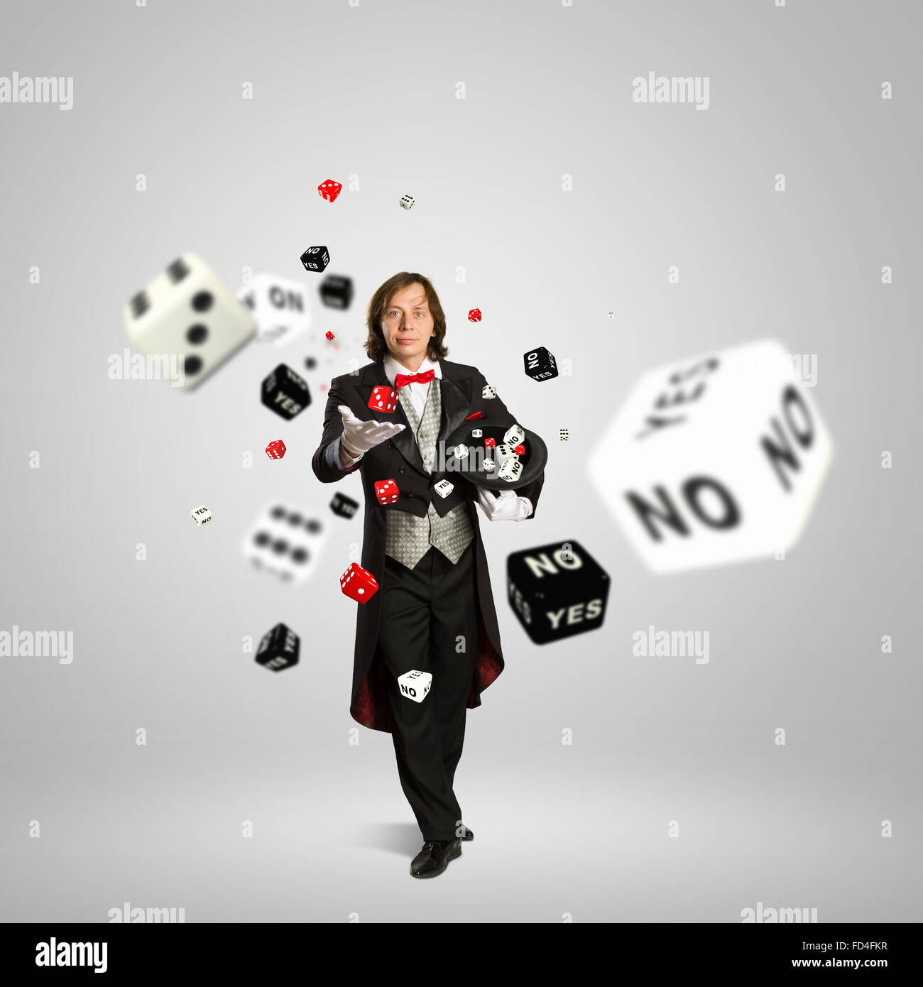Image of magician in red bow-tie throwing dice Stock Photo - Alamy