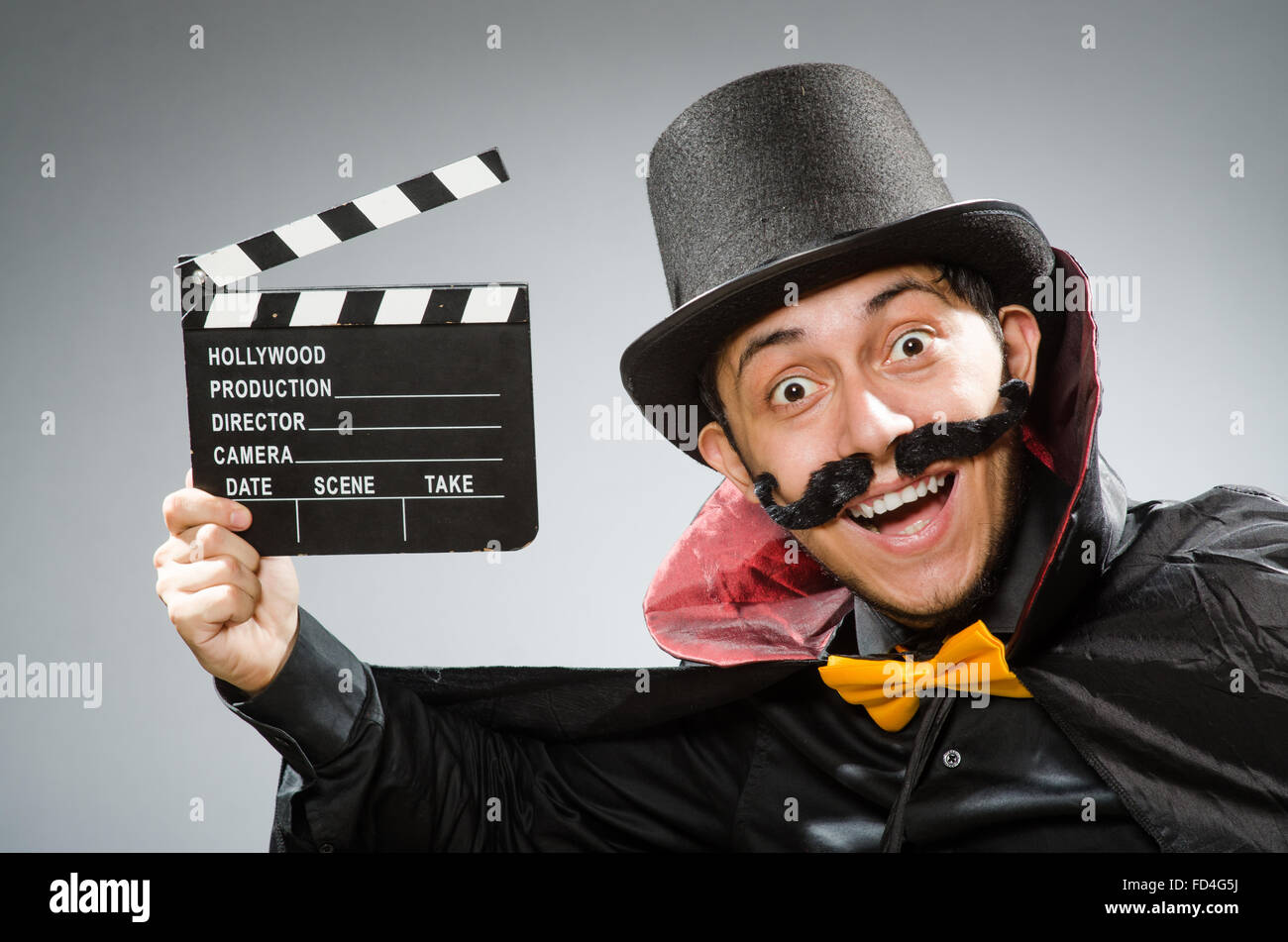 The funny man with movie clapboard Stock Photo - Alamy