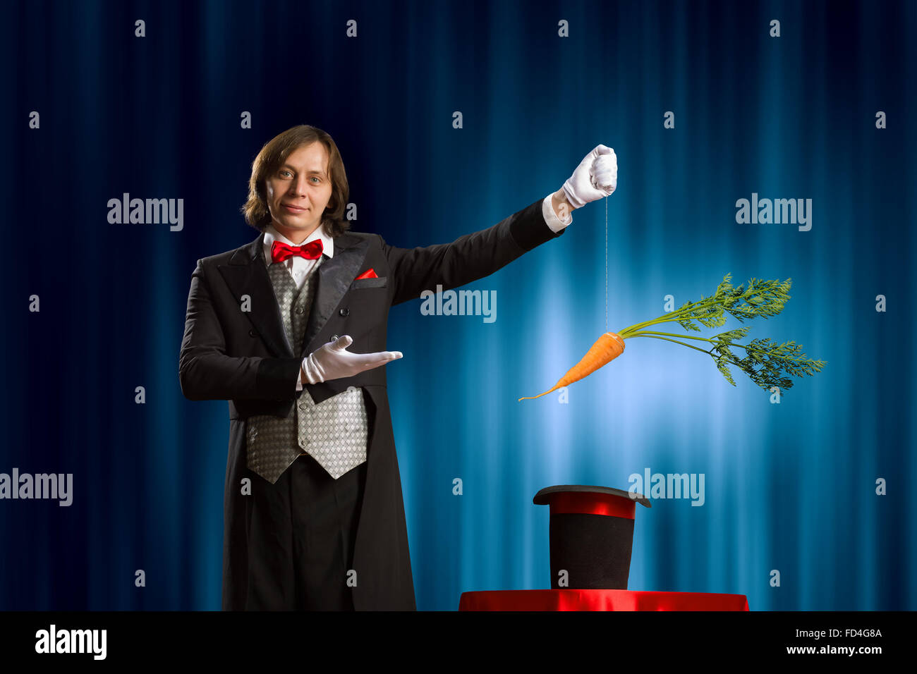 Image of magician taking carrot out of magic hat Stock Photo - Alamy