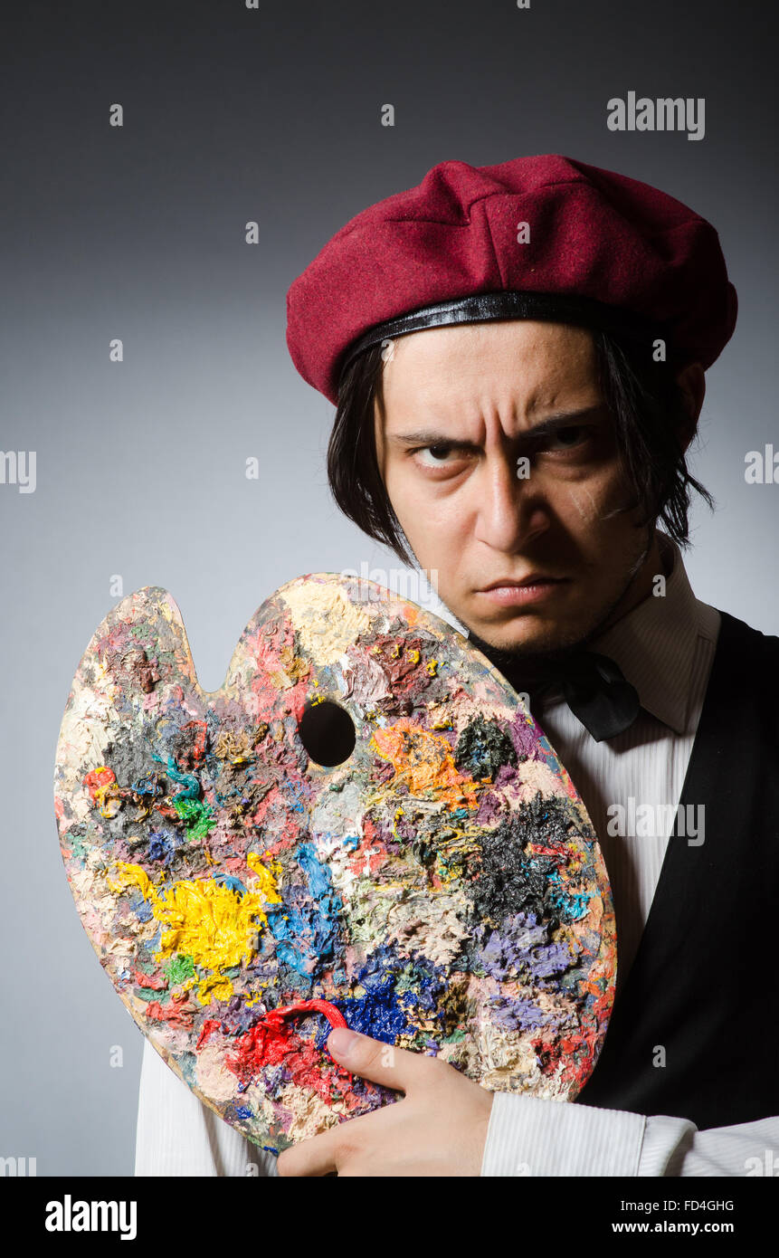 The funny artist in dark studio Stock Photo - Alamy