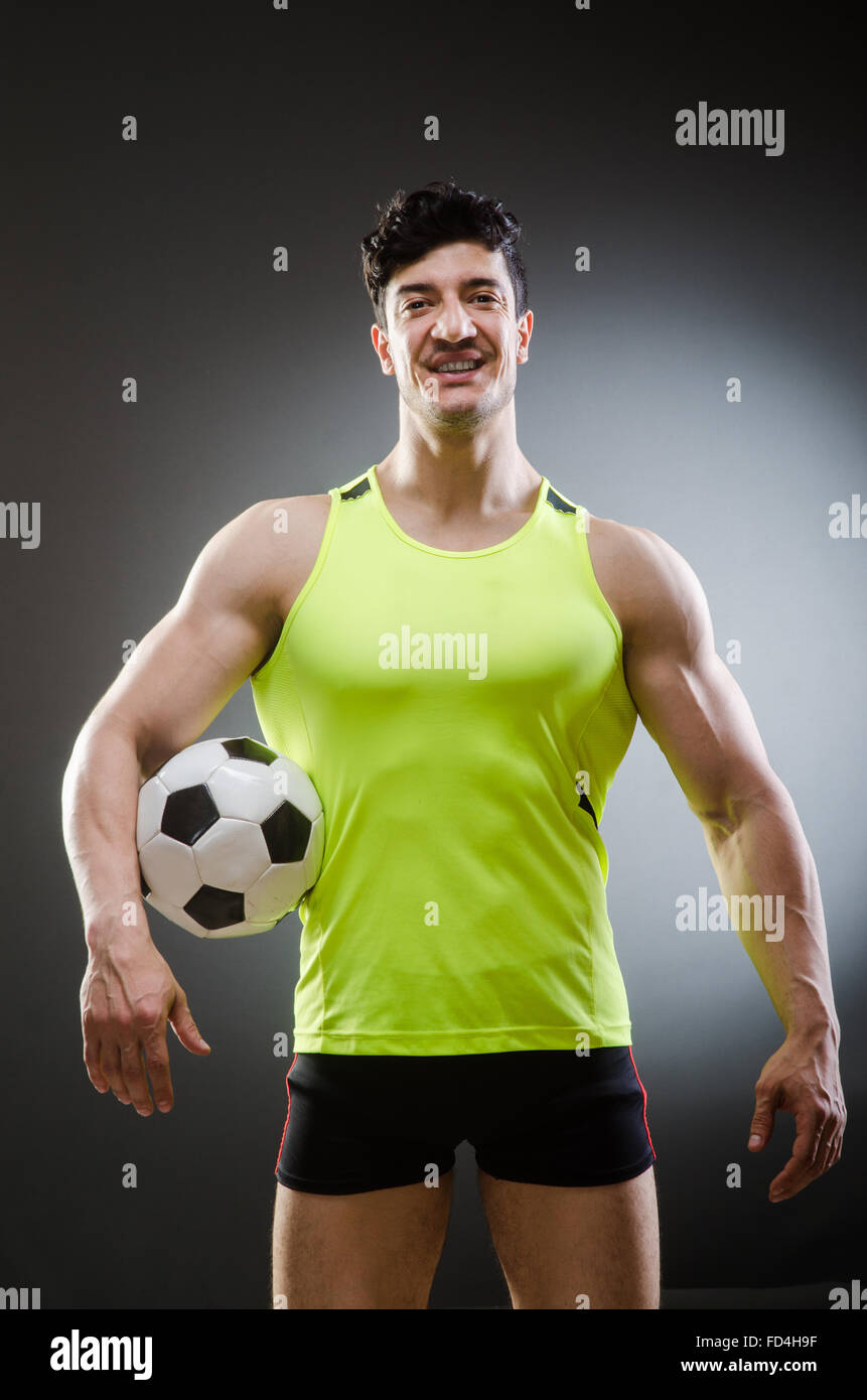 The muscular man with football ball Stock Photo - Alamy