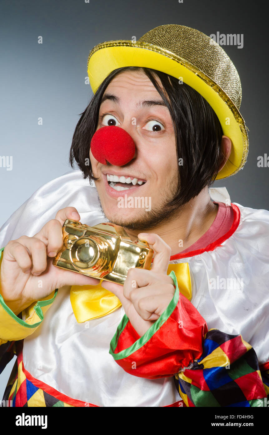 The funny clown against dark background Stock Photo - Alamy