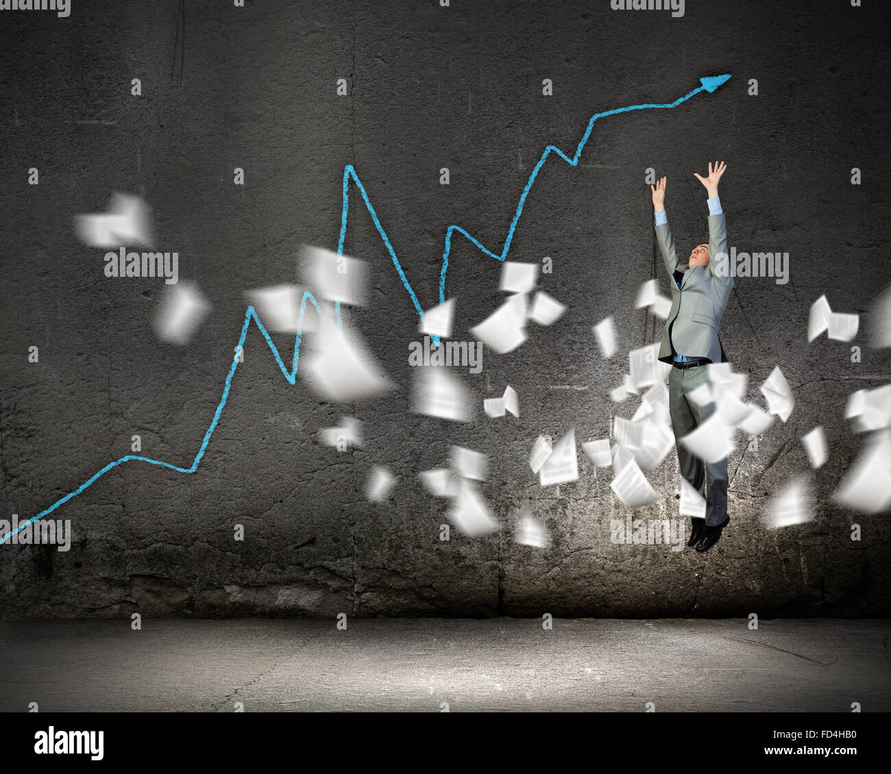 Image of jumping businessman trying to catch arrow of graph Stock Photo ...
