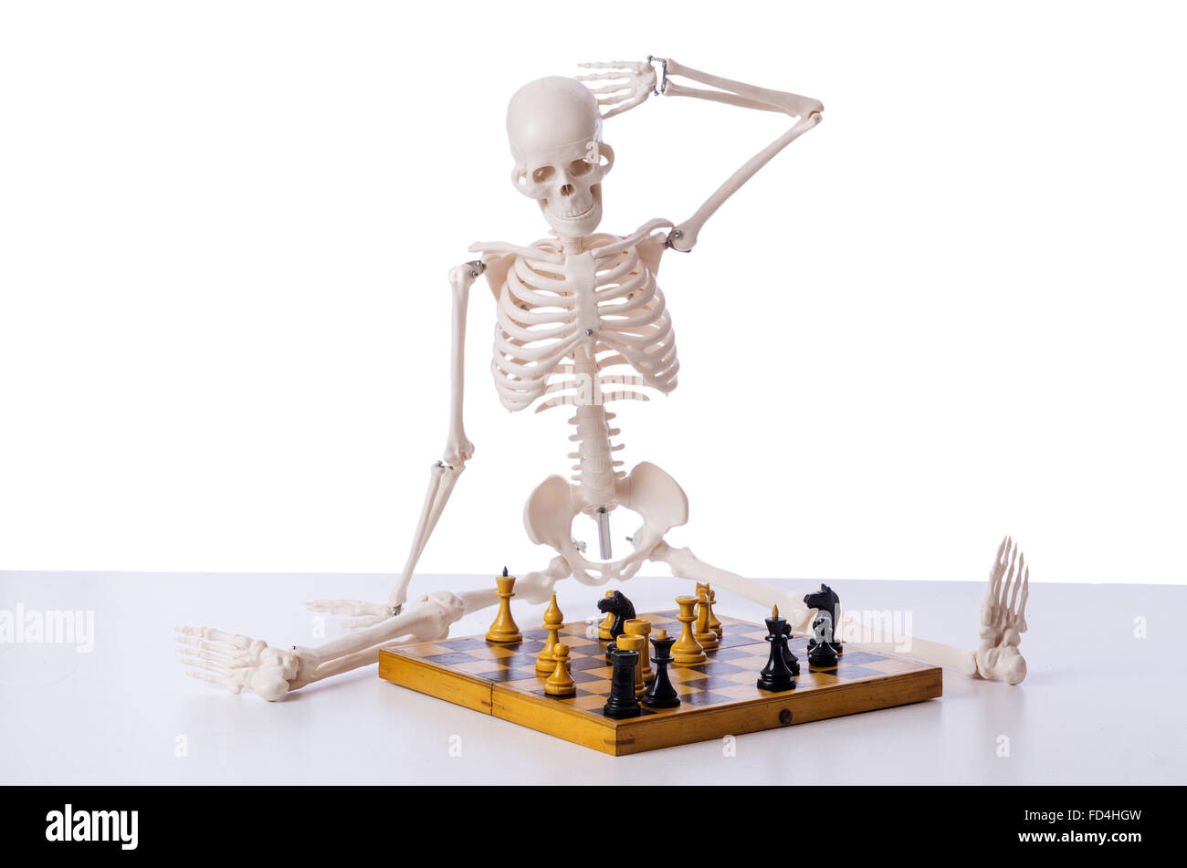 The skeleton playing chess game on white Stock Photo - Alamy