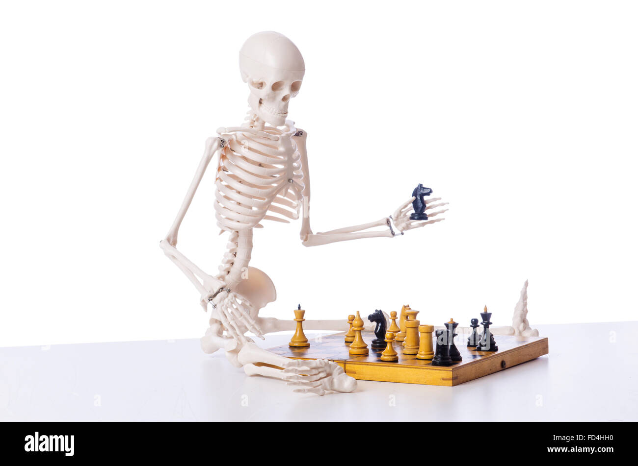 The skeleton playing chess game on white Stock Photo - Alamy