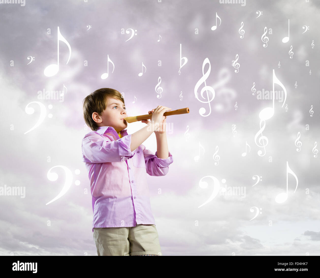 Image of little cute boy playing on flute against cloudy background ...