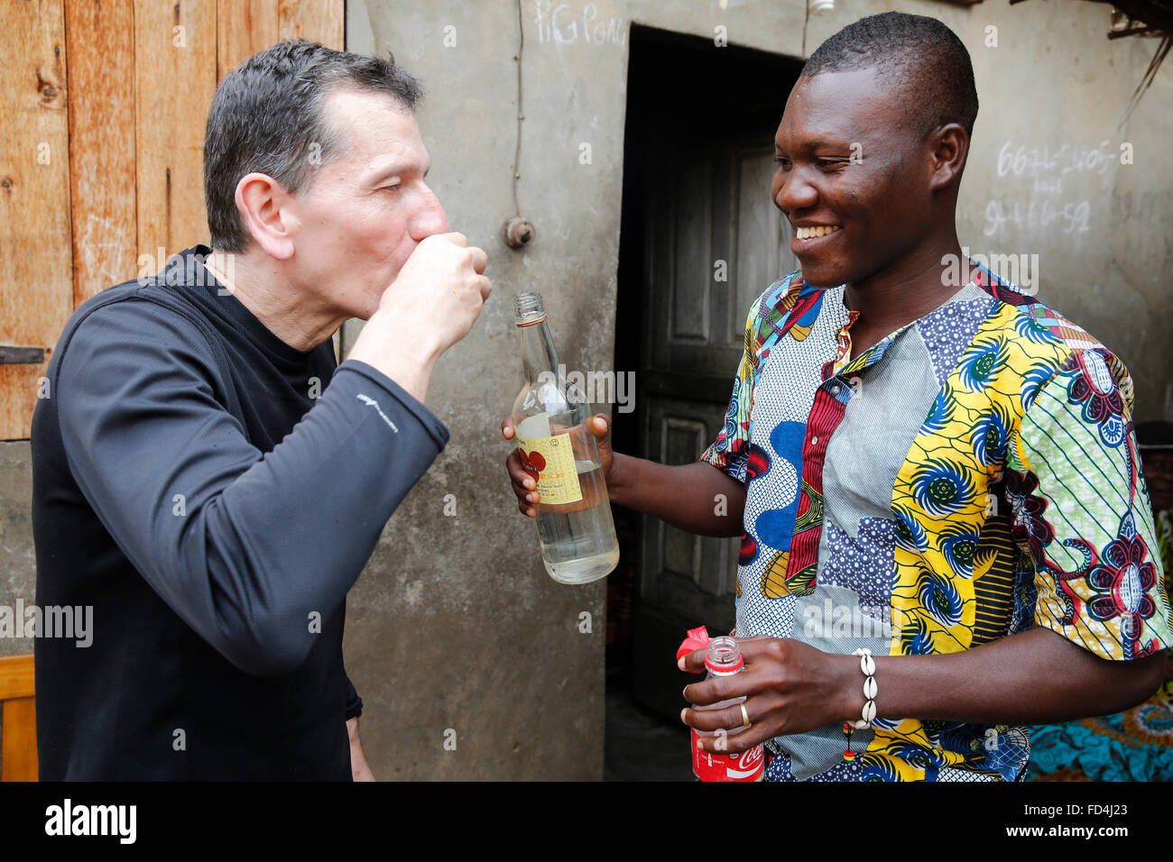 Gin and soft drink offered to a visitor in a Benin home Stock Photo - Alamy