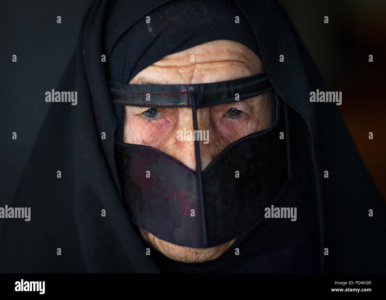 an old bandari woman wearing a traditional mask called the burqa, Qeshm ...