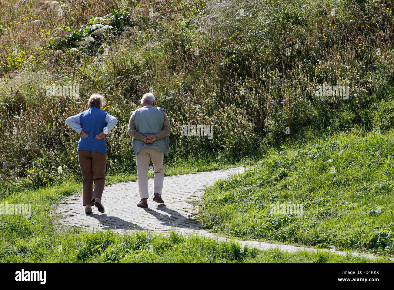 Couple walking on a path Stock Photo - Alamy
