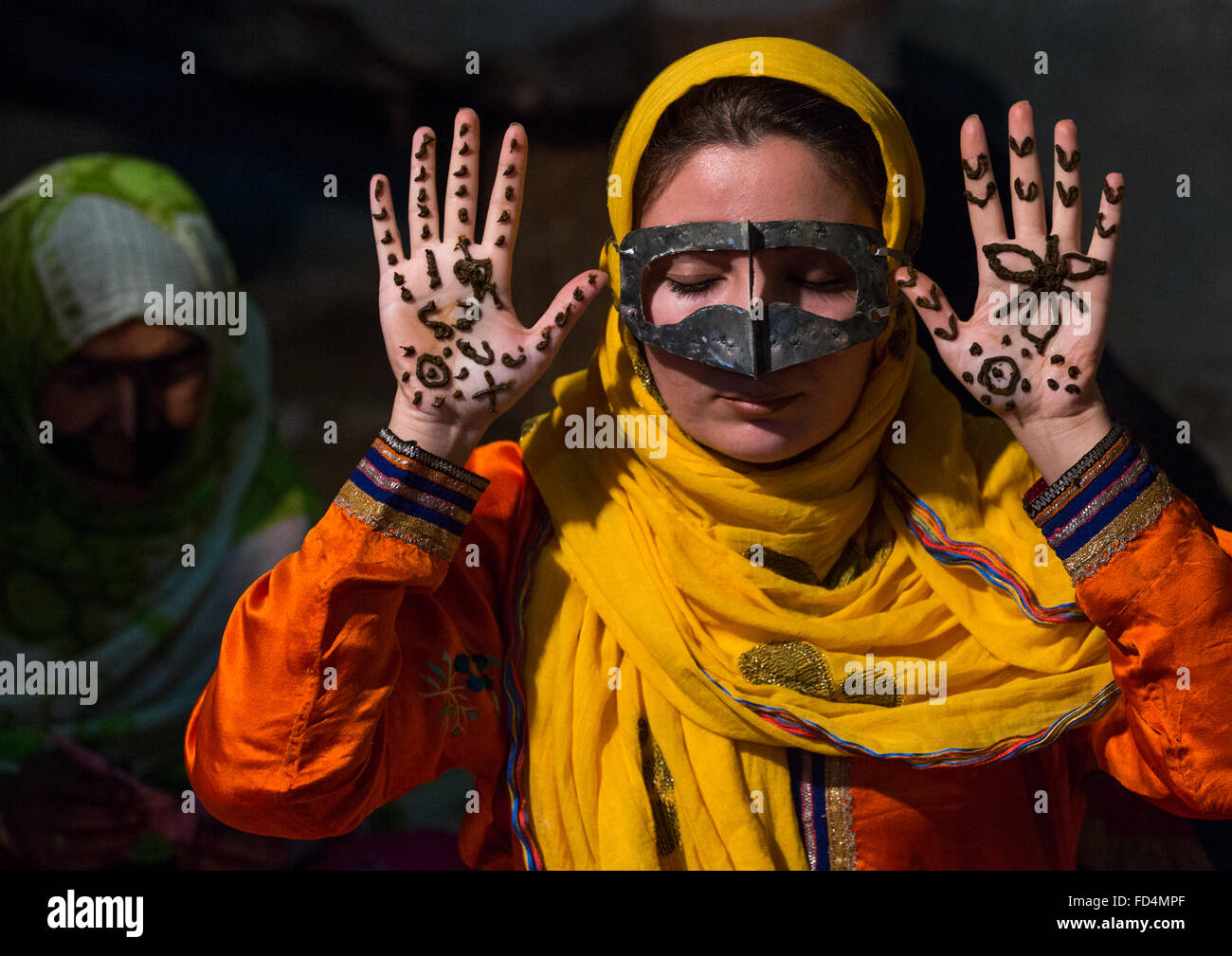 a bandari woman wearing a traditional mask during an artistic ...
