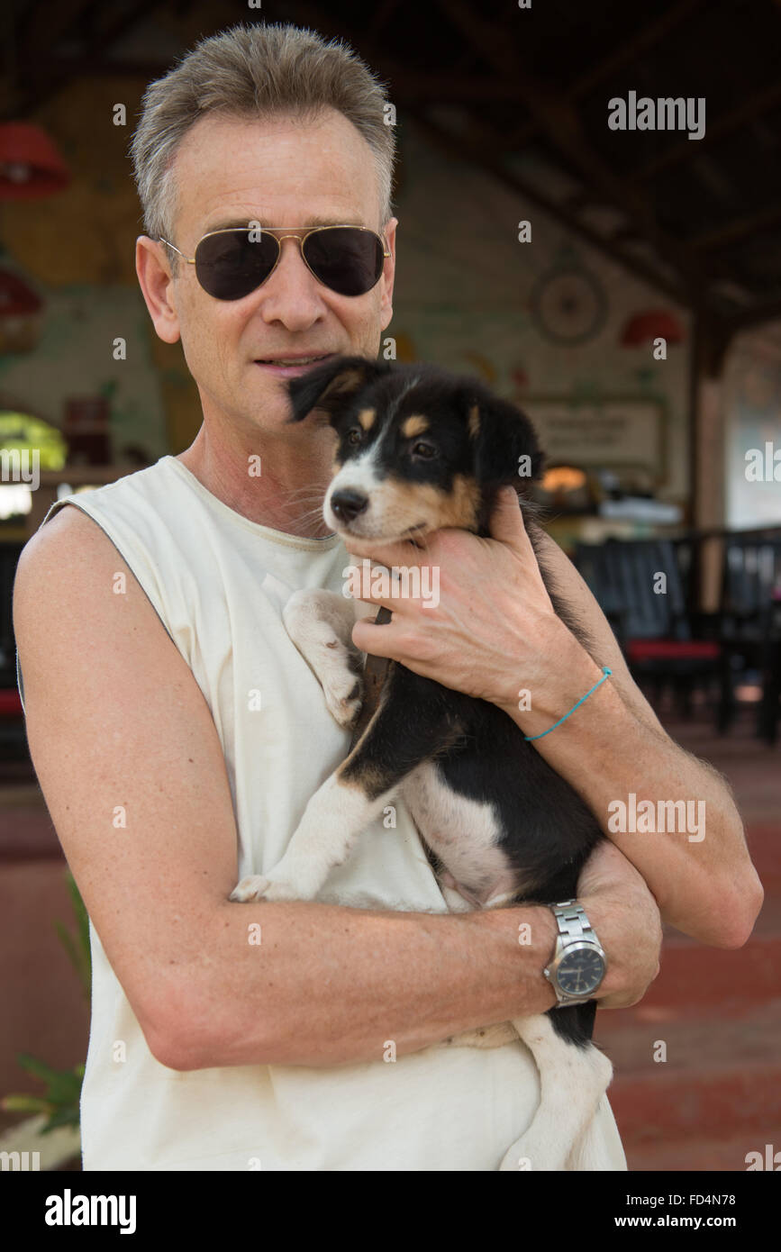 Man carrying a puppy Stock Photo - Alamy