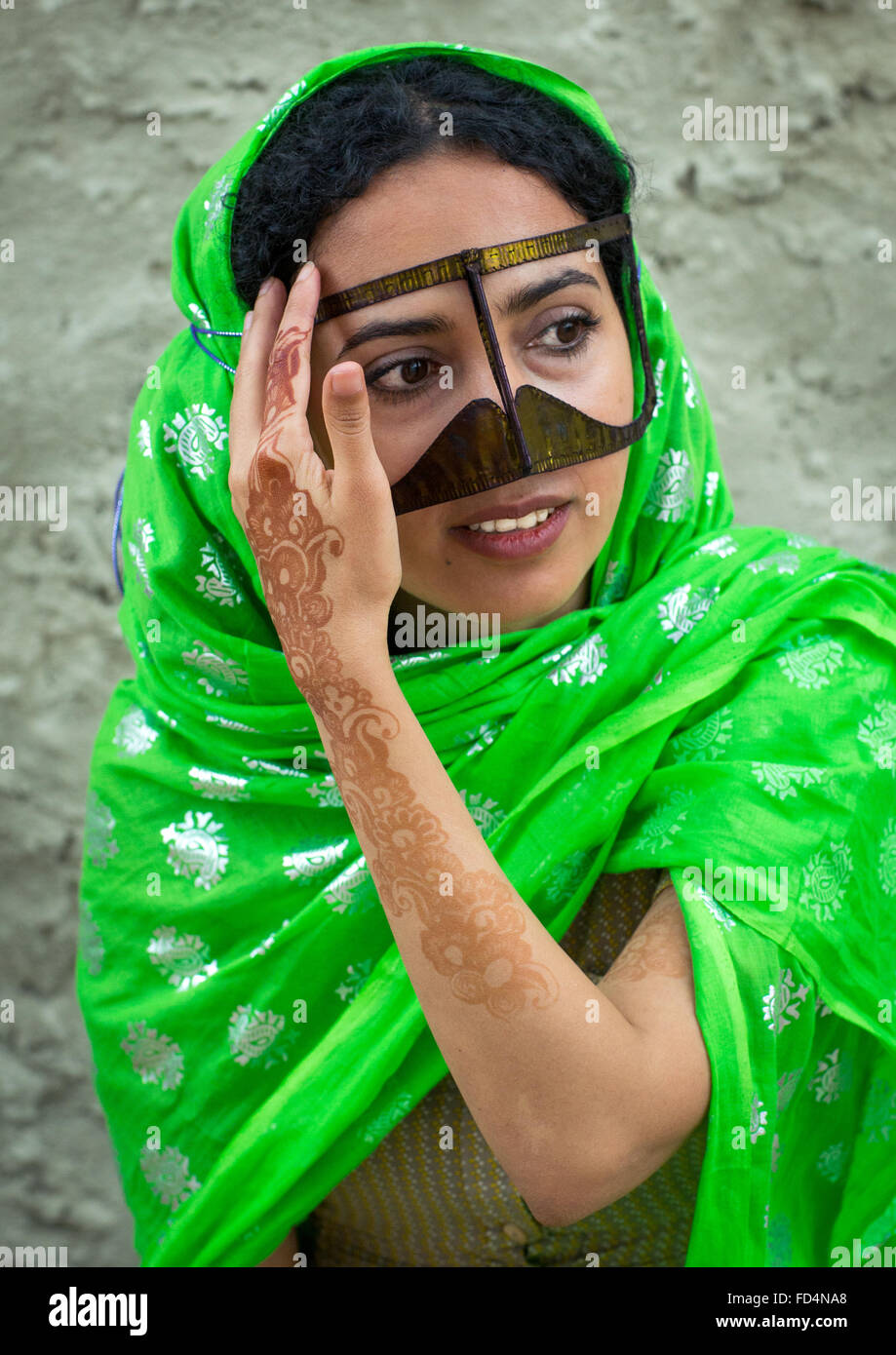 a bandari woman wearing a traditional mask called the burqa with a ...
