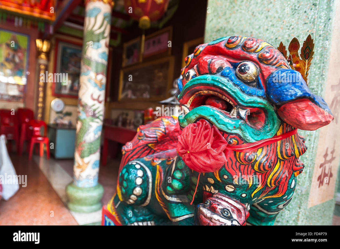 Colourful lion guardian at the entrance to a Chinese temple in Bangkok ...