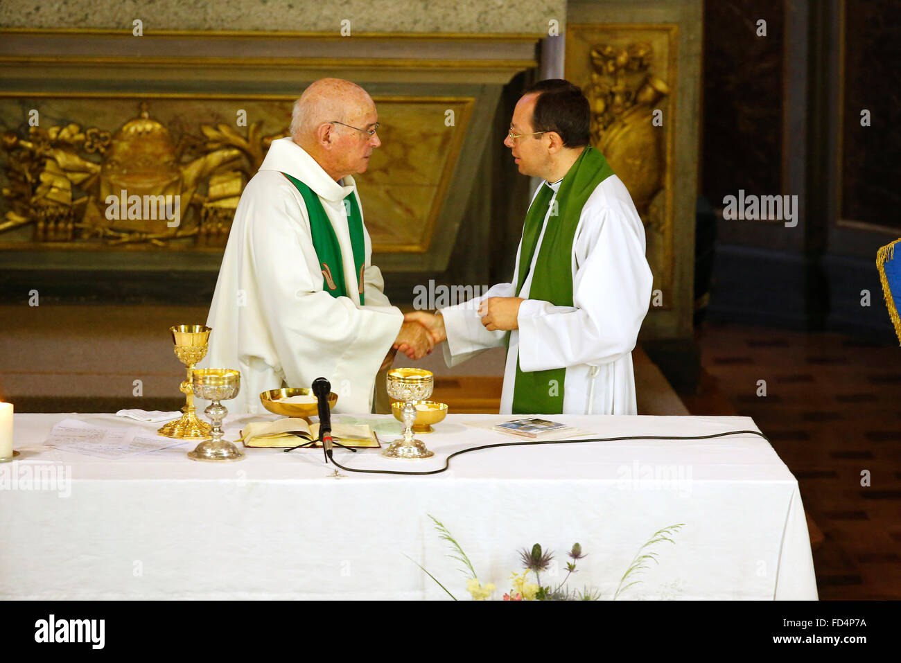 Catholic mass. Peace giving Stock Photo - Alamy