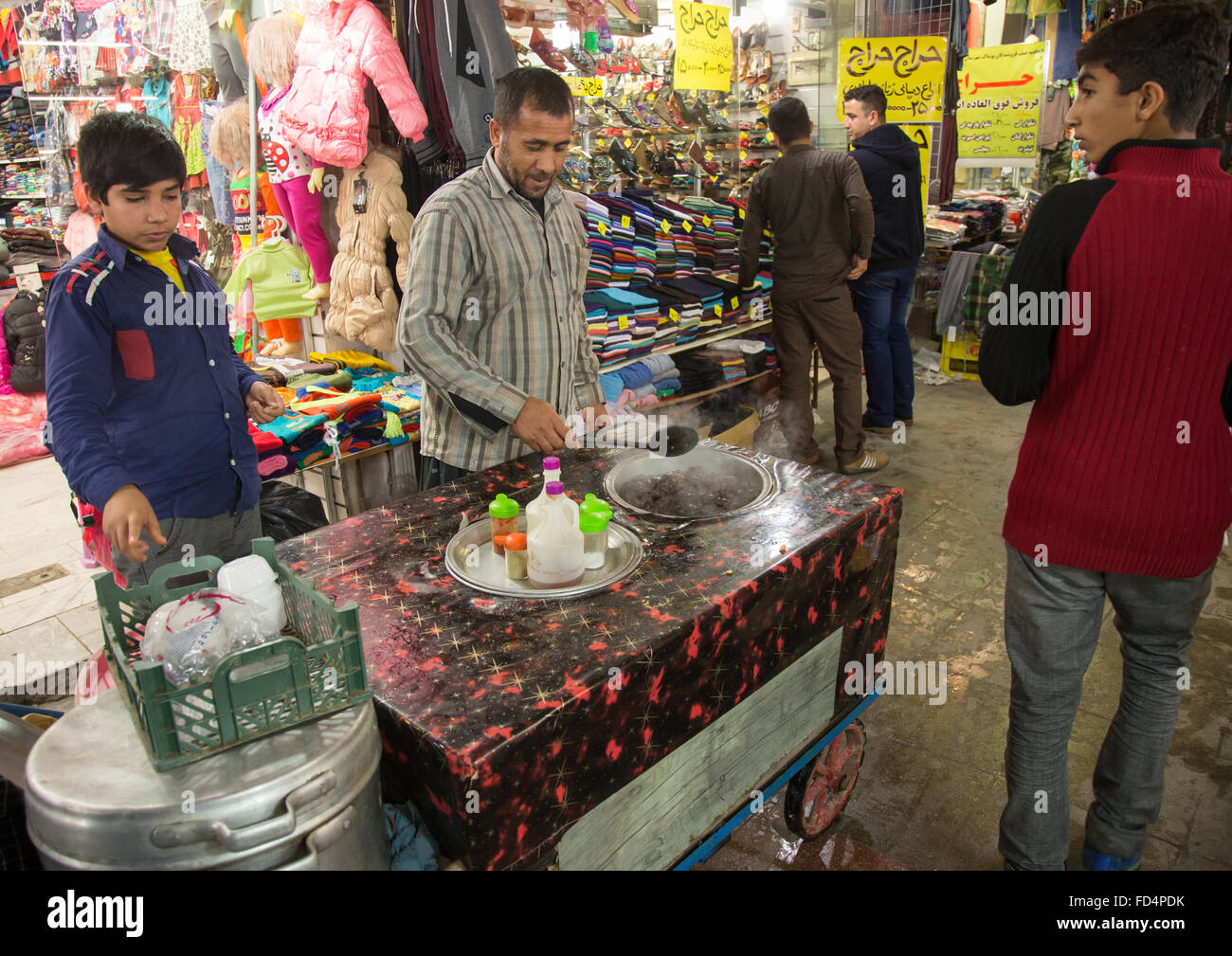 man selling food in the bazaar with a mobile food stall, Hormozgan ...