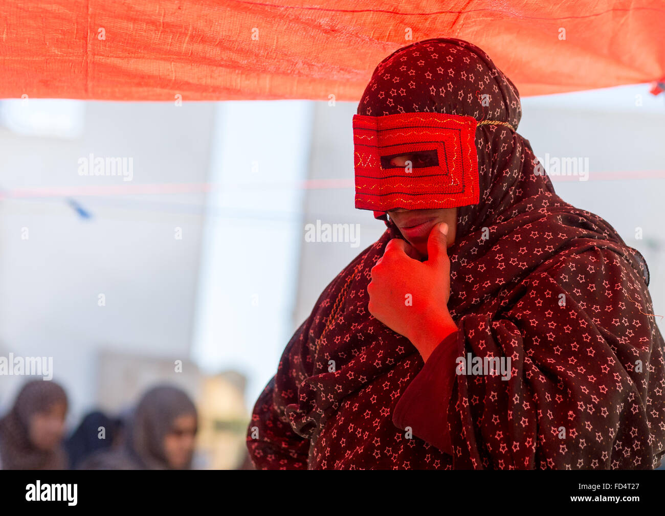 a bandari woman wearing the traditional mask called the burqa on a ...