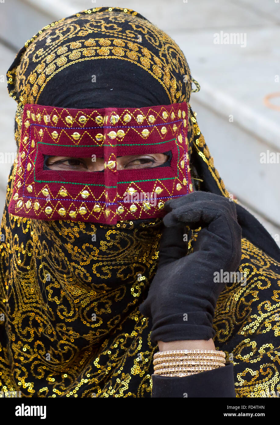 a bandari woman wearing the traditional mask called the burqa on a ...