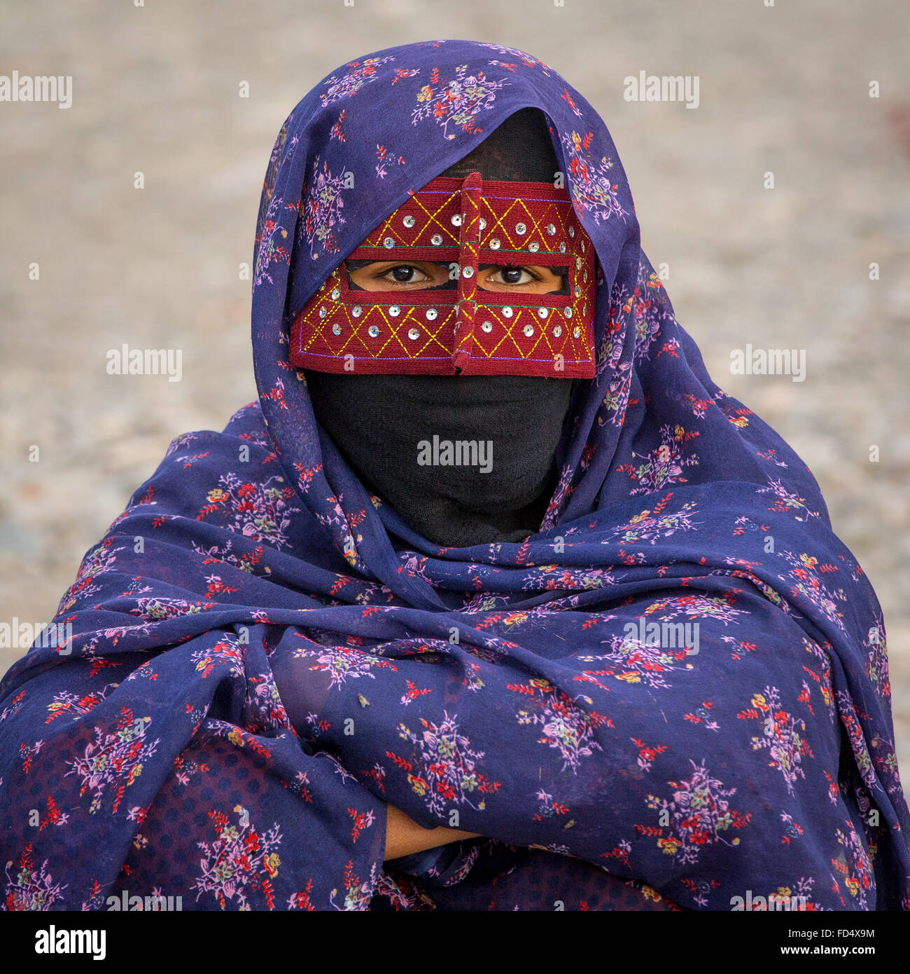 a bandari woman wearing a traditional mask called the burqa at ...