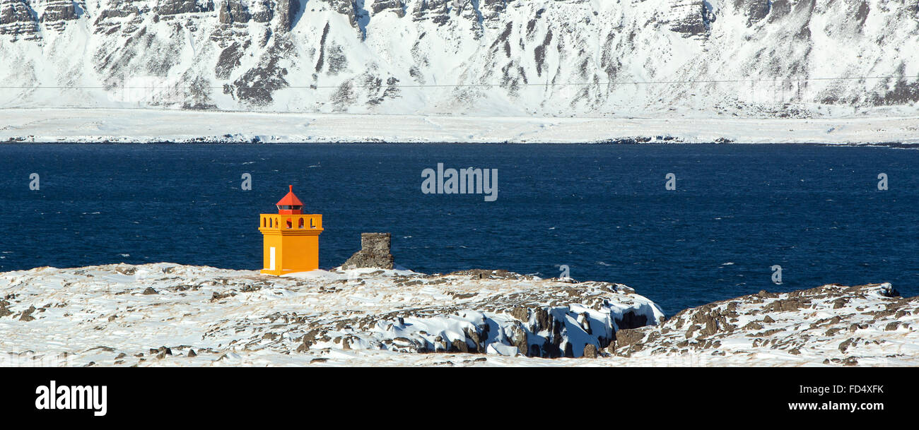 Wide shot panorama of an orange lighthouse on the coast, Iceland Stock ...