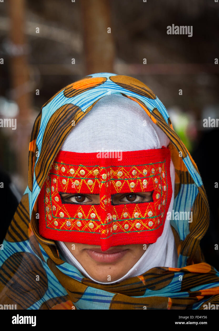 a bandari woman wearing a traditional mask called the burqa at ...