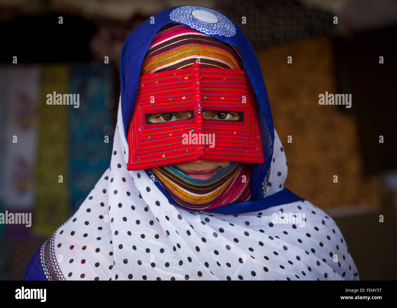 a bandari woman wearing a traditional mask called the burqa at ...