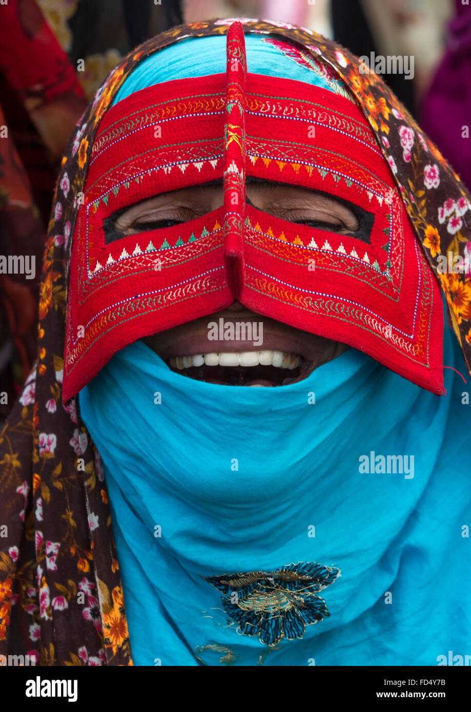 a laughing bandari woman wearing a traditional mask called the burqa at ...