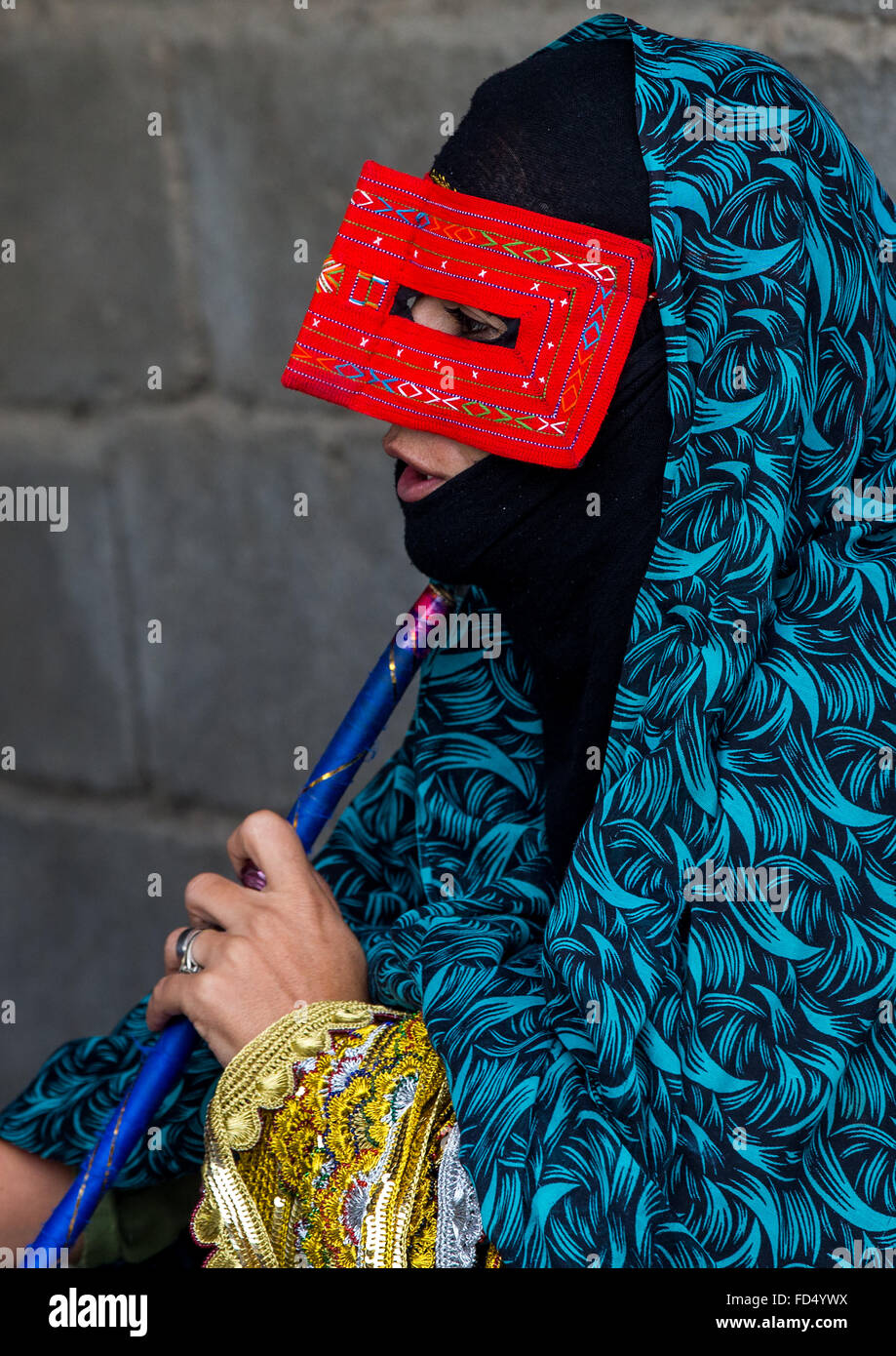 a bandari woman wearing a traditional mask called the burqa at ...