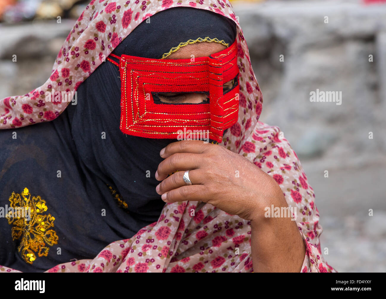 a bandari woman wearing a traditional mask called the burqa at ...