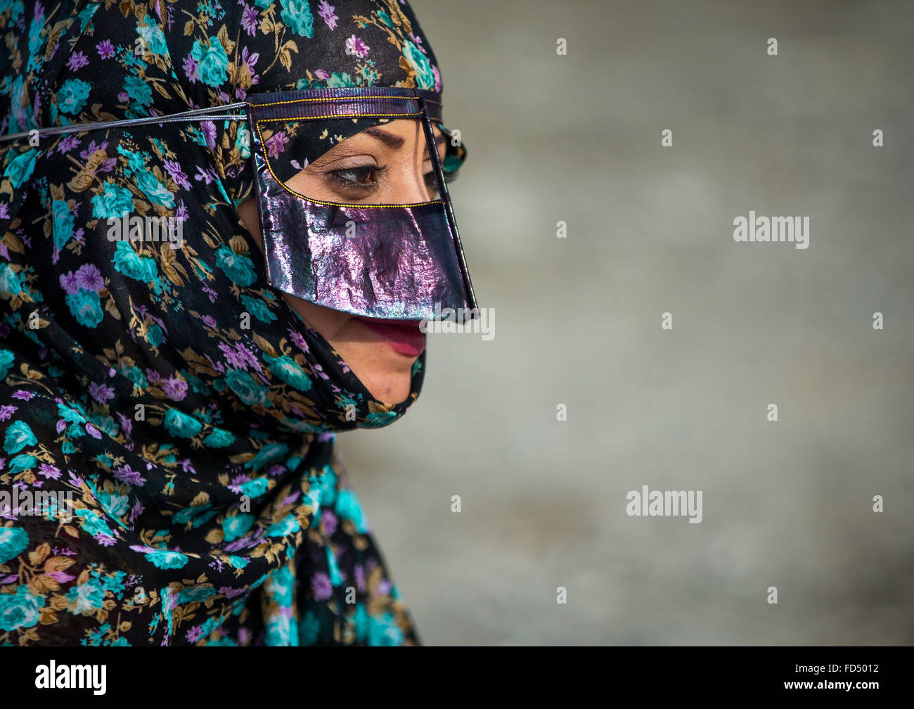 a bandari woman wearing a traditional mask called the burqa at ...