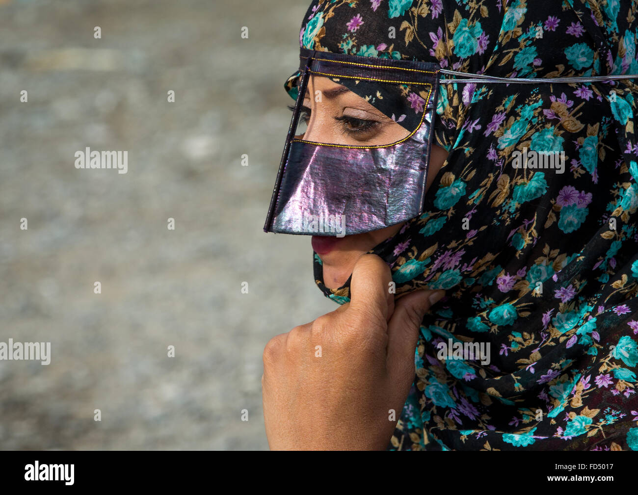 a bandari woman wearing a traditional mask called the burqa at ...