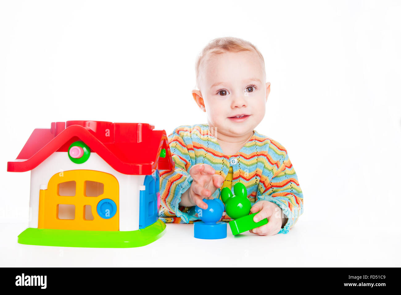 Cute baby play with toy house Stock Photo - Alamy